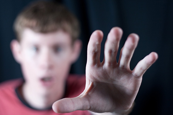 boy holding out his hand to say stop